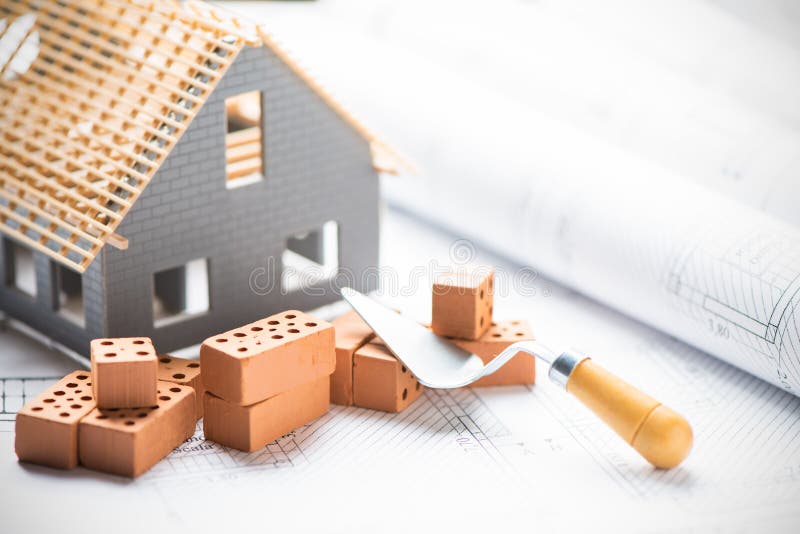 House Under Construction on Blueprints. Building Project Concept Stock ...