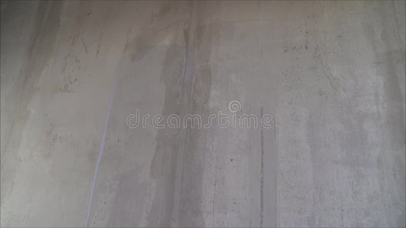 Primer Application by Roller. the House is Under Construction. Worker ...