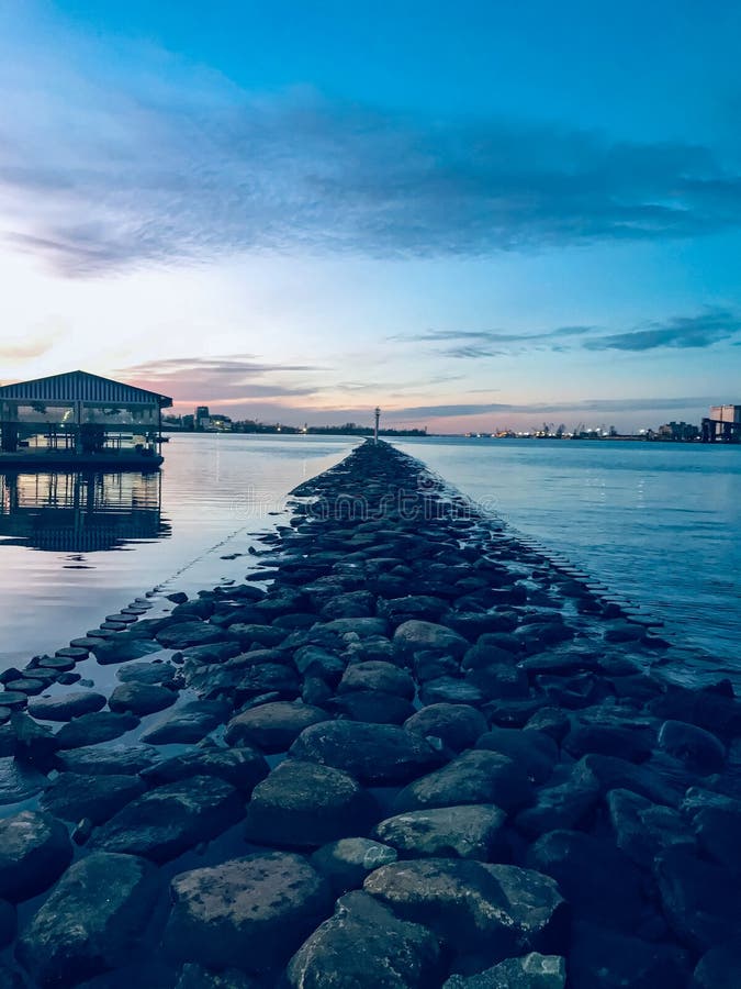 House on the Water and Pier Made from Rocks Stock Photo - Image of lake ...