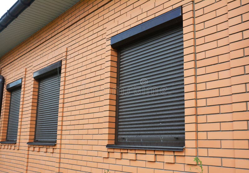 House Windows with Rolling Shutters for Home Protection. Stock Photo ...