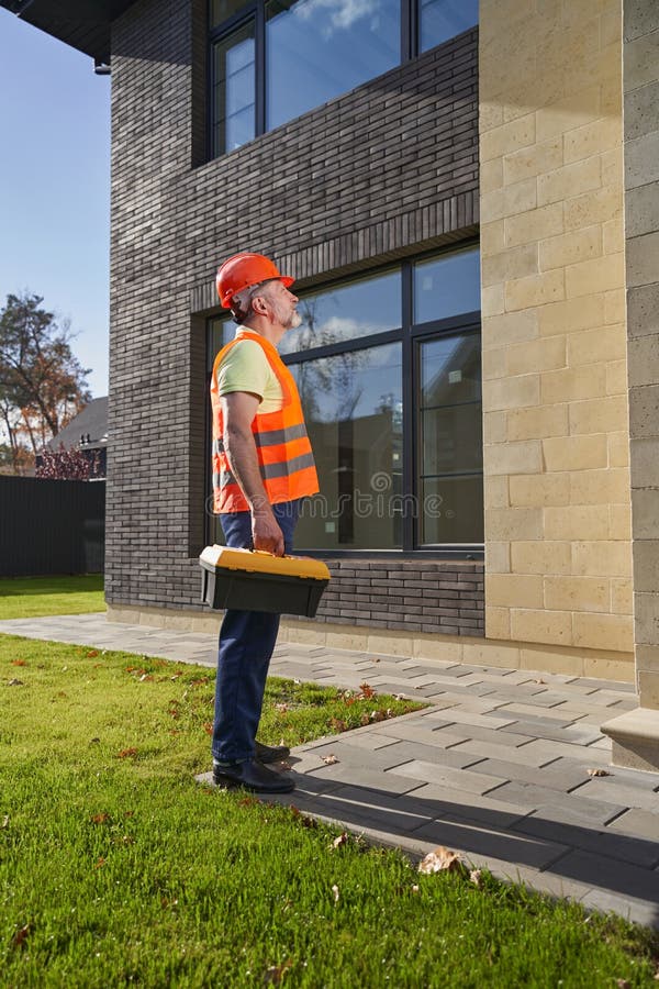 Housebuilder with Set of Instruments Looking at Building Stock Image ...