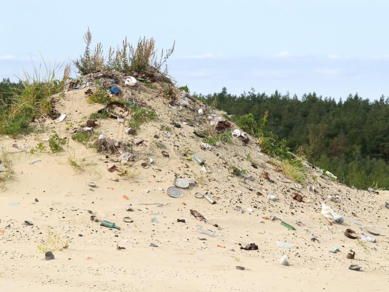 The Household Garbage Rolls on the Sandy Hill. Stock Photo - Image of ...