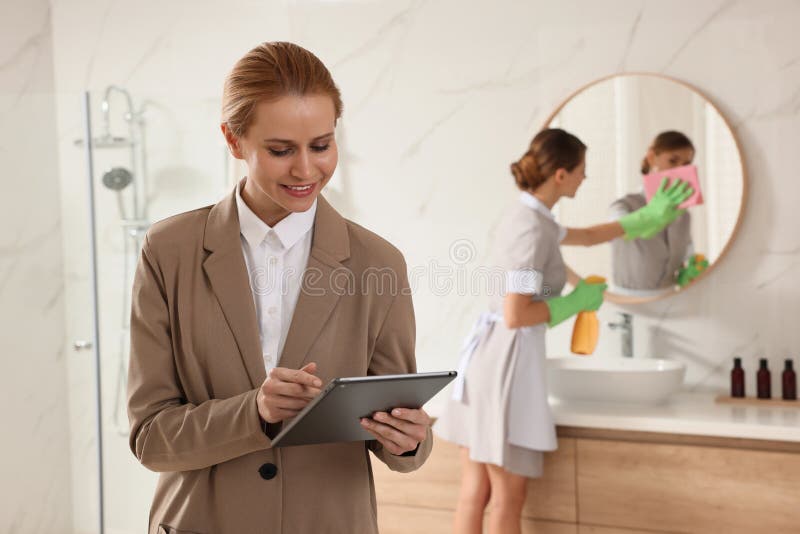Housekeeping Manager with Tablet Checking Maid`s Work in Hotel Bathroom ...