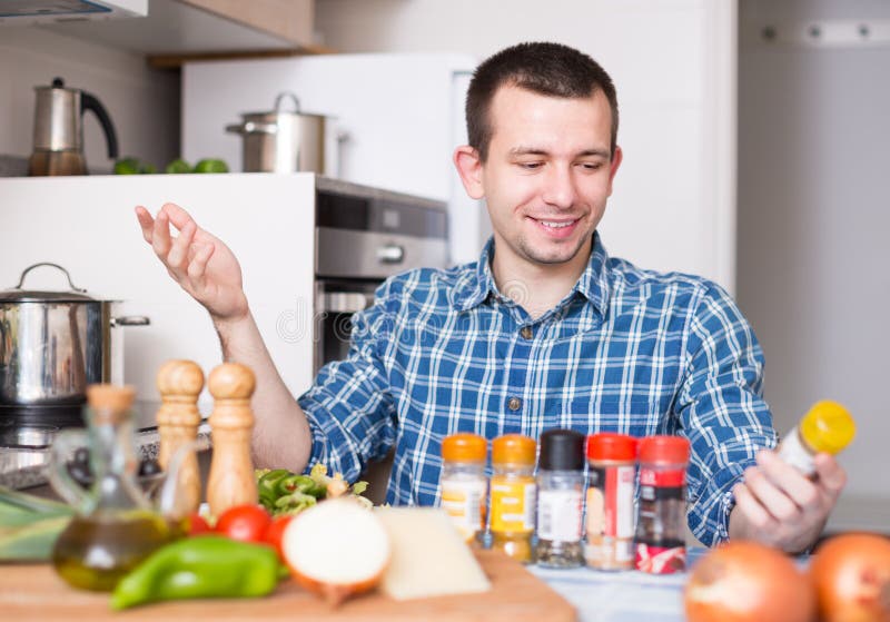 Normal Guy Chooses Spices in the Kitchen at Home Stock Image - Image of ...