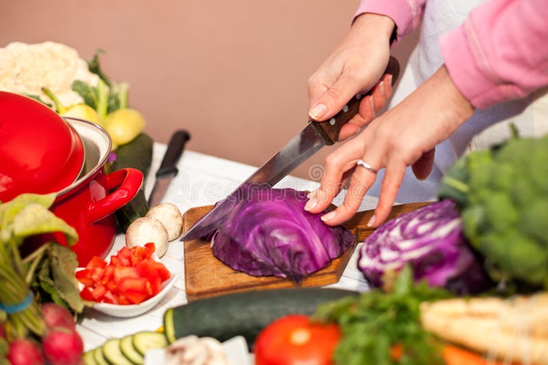 Housewife Cutting Red Cabbage on Slices in the Kitchen Stock Image ...