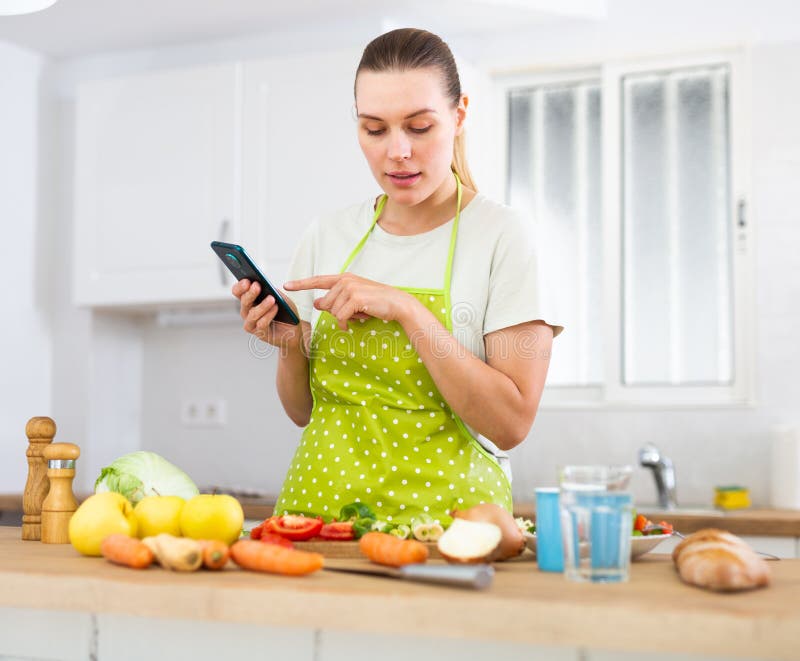Housewife Looking for Recipe on Internet Using Smart Phone in the ...