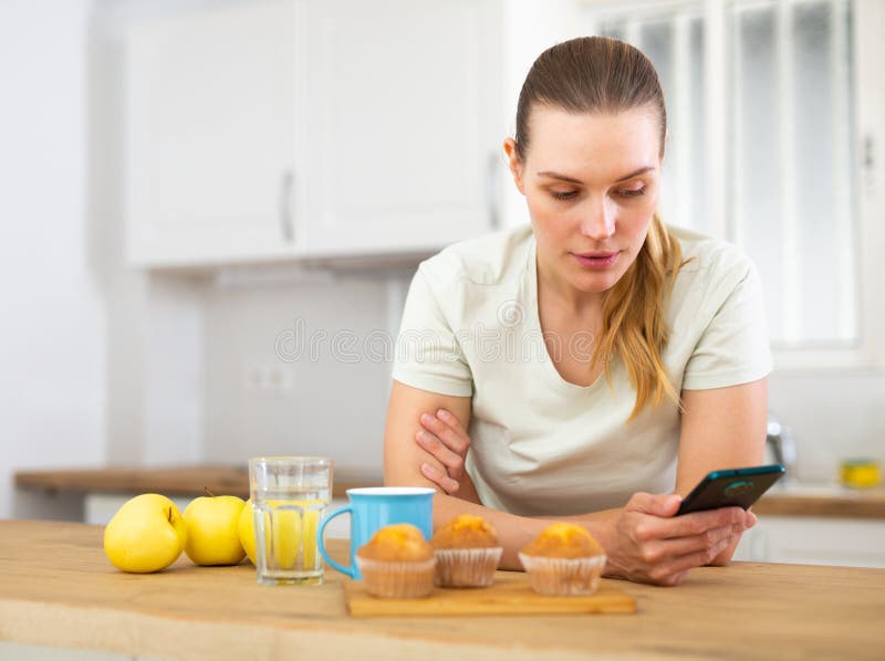 Housewife Looking for Recipe on Internet Using Smart Phone in the ...