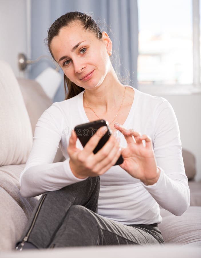 Housewife Using Her Mobile Phone Stock Photo - Image of homey, chatting ...