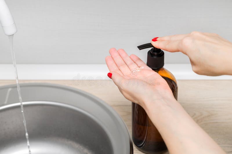 Housewife Using Liquid Soap Dispenser in the Kitchen Stock Image ...