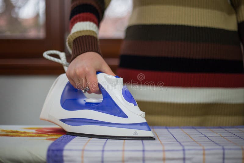 Housewife Work, a Housewife Does Her Job,iron and Ironing Board ...