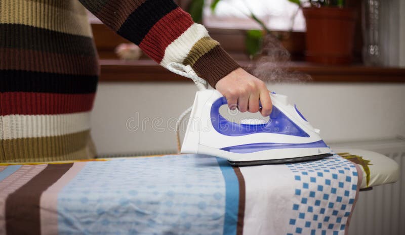 Housewife Work, a Housewife Does Her Job,iron and Ironing Board ...