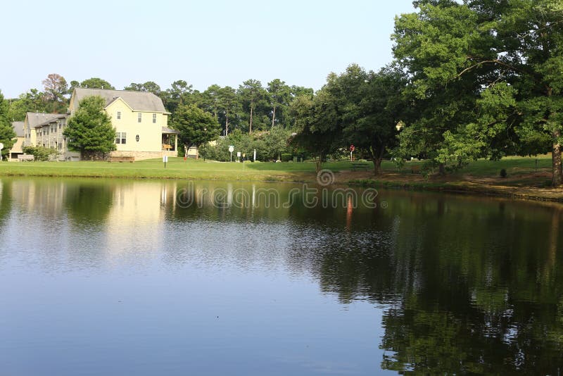 Housing Development with Green Trees and a Lake Water Reflection Stock ...