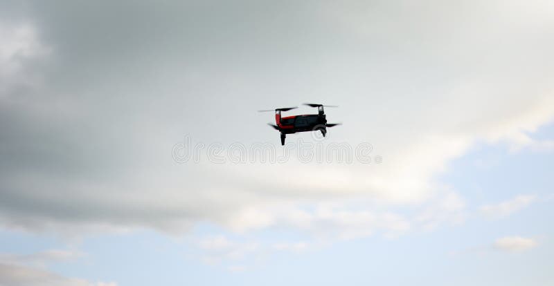 Hovering Drone Flying Upward on a Cloudy Sky Backdrop. Copter Flying ...