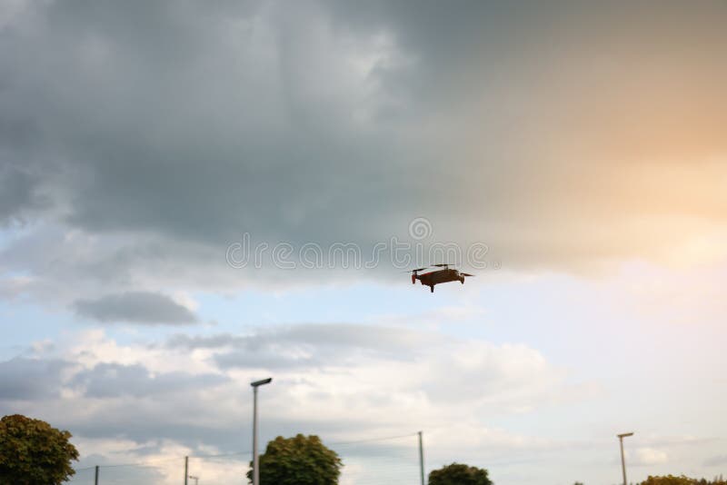 Hovering Drone Flying Upward on a Cloudy Sky Backdrop. Copter Flying ...