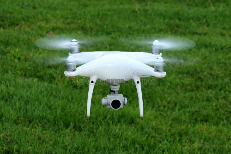Hovering Drone with Grass Background Stock Photo - Image of technology ...