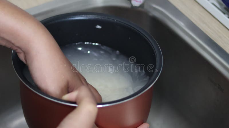 How To Cook Rice. Rinse the Rice with Clean Water Stock Footage - Video ...
