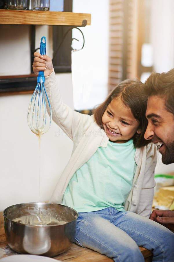 Hows this, Dad. a Father and Daughter Making Pancakes Together. Stock ...