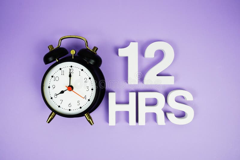 12 Hrs Alphabet Letters and Alarm Clock Top View on Purple Background ...