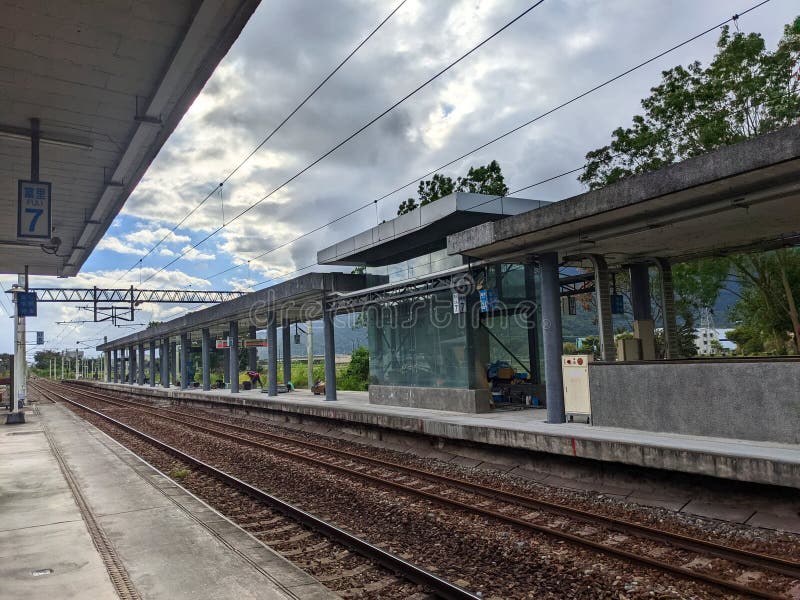 An Empty Platform in Fuli Railway Station with a Worker Working on the ...