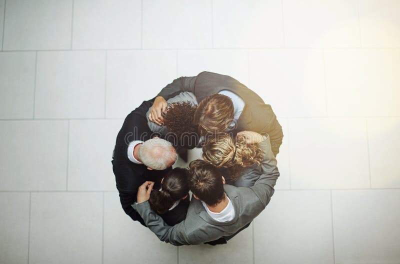 In the Huddle. High Angle Shot of a Group of Businesspeople Standing in ...