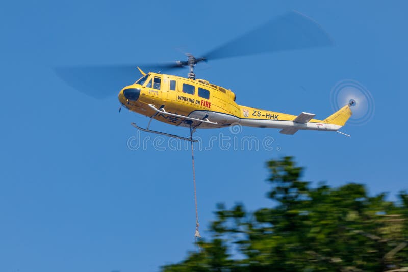 Huey Firefighting Helicopter Over Green Trees Editorial Photo - Image ...