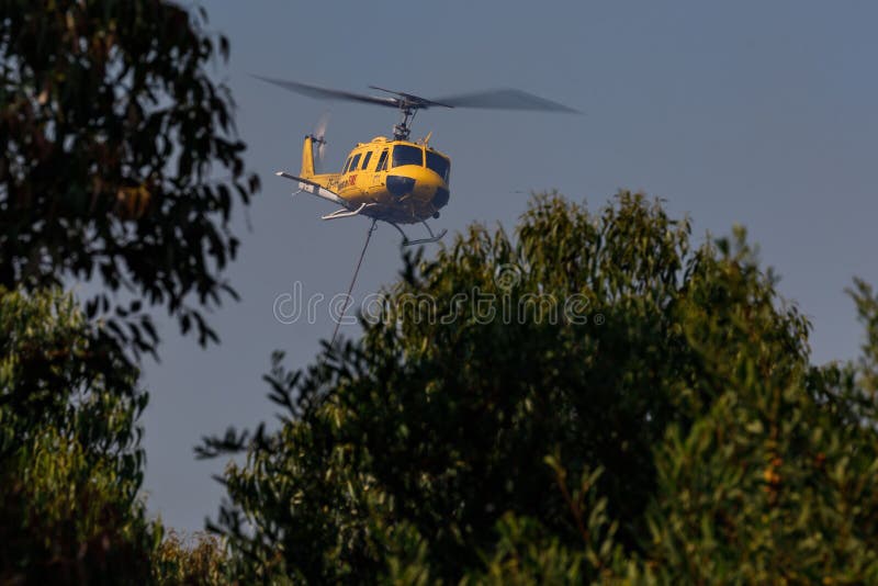 Huey Firefighting Helicopter Over Green Trees Editorial Stock Image ...