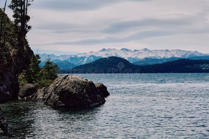 A Huge Boulder on the Shore of a Blue Lake Stock Photo - Image of ...