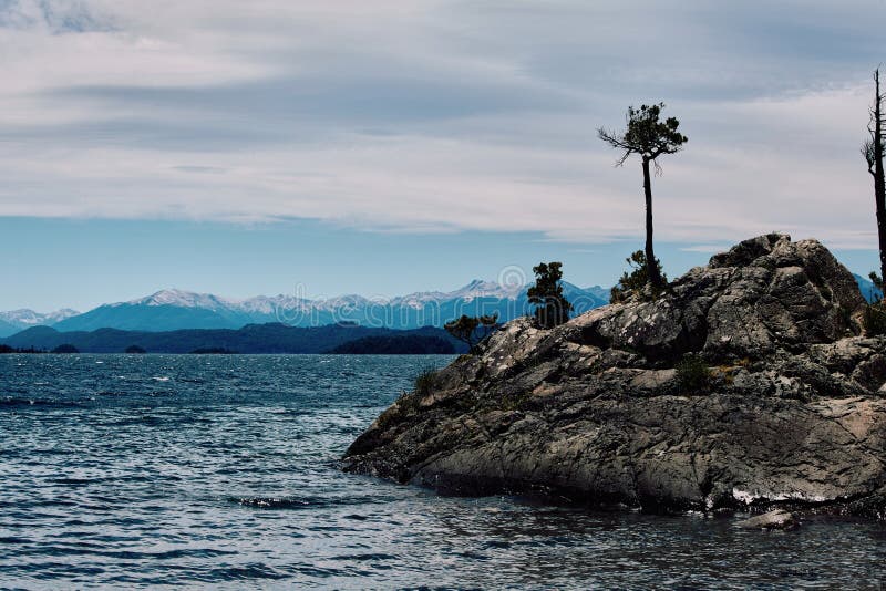 A Huge Boulder on the Shore of a Blue Lake Stock Photo - Image of ...