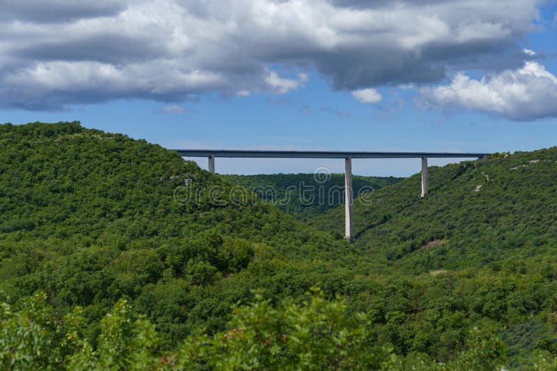 A Huge Bridge on Three Supports Over a Valley between Two Forested ...