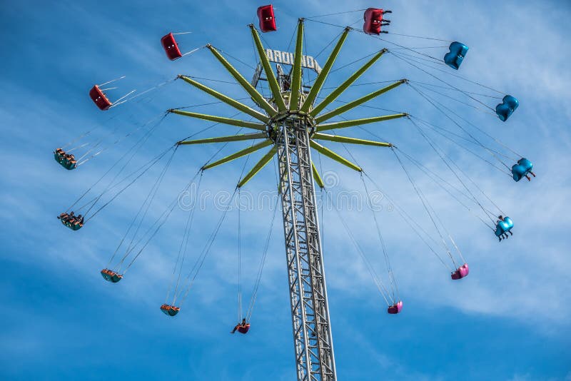 Huge Chain Carousel with Gondolas in Front of a Bright Blue Sky ...