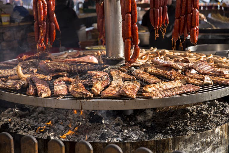 Huge Circular Grill with Assorted Meat on the Embers Stock Image ...