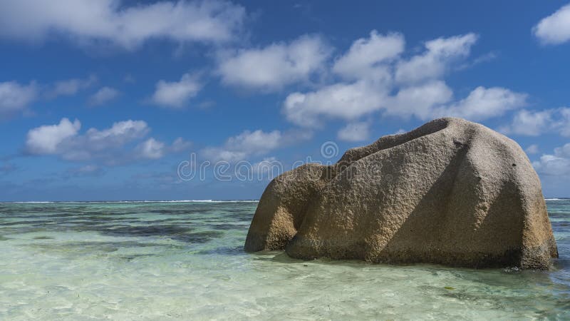 A Huge Granite Boulder with Folded Slopes Rises in the Ocean. Stock ...