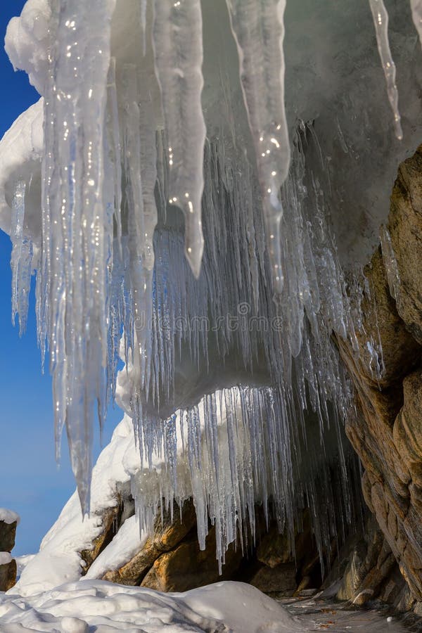 Huge icicles on a cliff. stock image. Image of reflection - 70920897