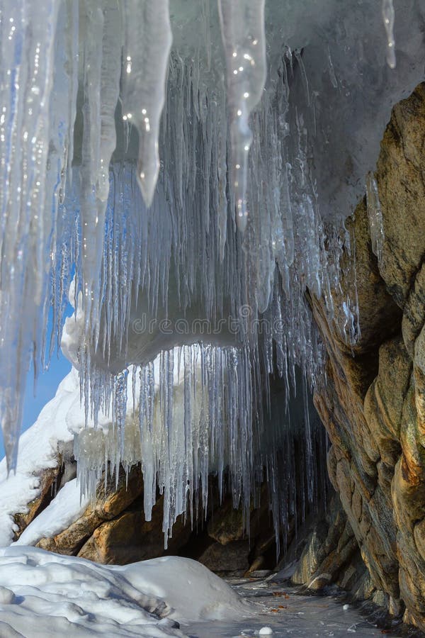 Huge icicles on a cliff. stock photo. Image of dawn, grotto - 71597544