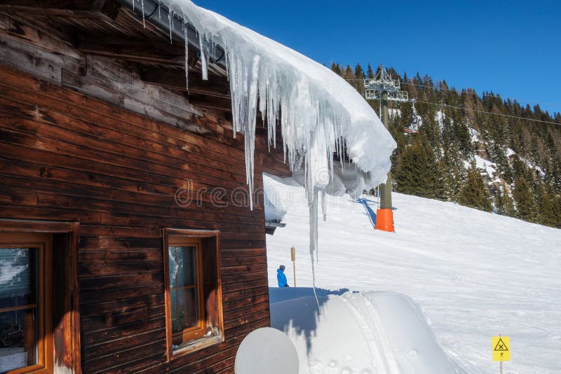 Huge Icicles Hang from a Roof in the Mountains Stock Photo - Image of ...