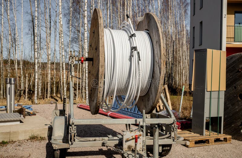 Huge Industrial Wooden Cable Spool with Coiled White Cable on a Mobile ...