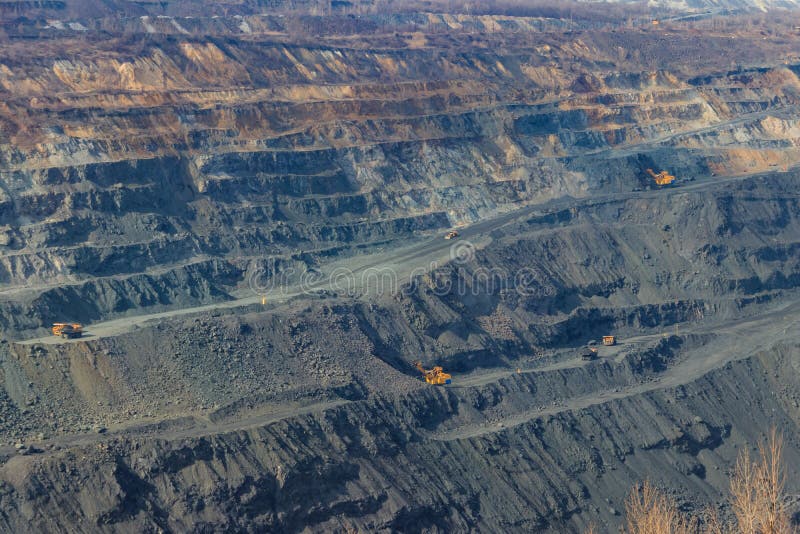 Huge Iron Ore Quarry with Working Dump Trucks and Excavators Stock ...