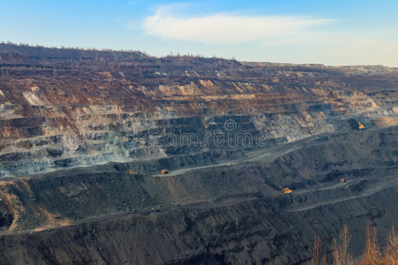 Huge Iron Ore Quarry with Working Dump Trucks and Excavators Stock ...