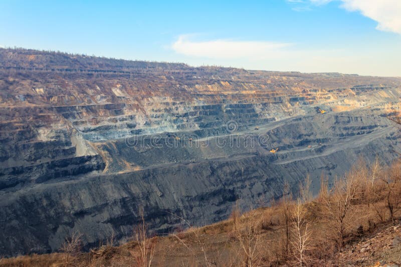 Huge Iron Ore Quarry with Working Dump Trucks and Excavators Stock ...
