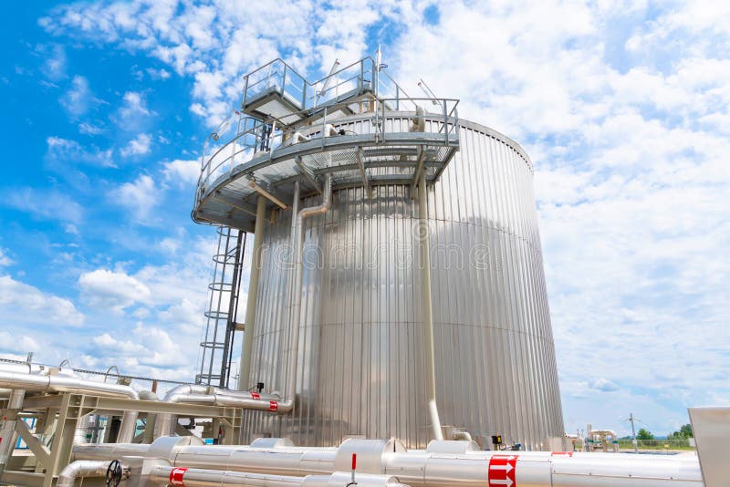 A Huge Metal Tank at a Production Facility Surrounded by Pipes Stock ...
