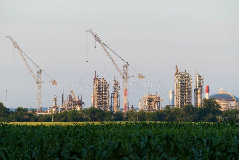 A Huge Oil Refinery with Cranes Under Construction Stock Photo - Image ...