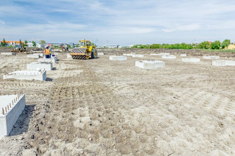 Huge Road Roller with Spikes is Compacting Soil at Construction ...
