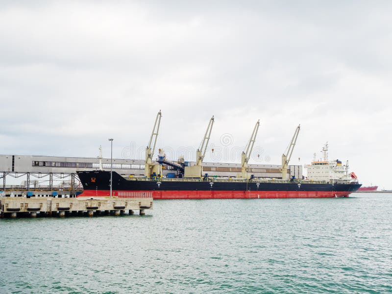 A Huge Ship with Loading Cranes Stands in the Seaport Stock Photo ...