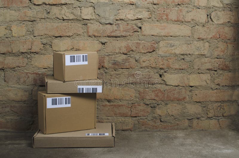 Stack of Parcels on the Floor Against Brick Wall.Empty Space.Storage ...