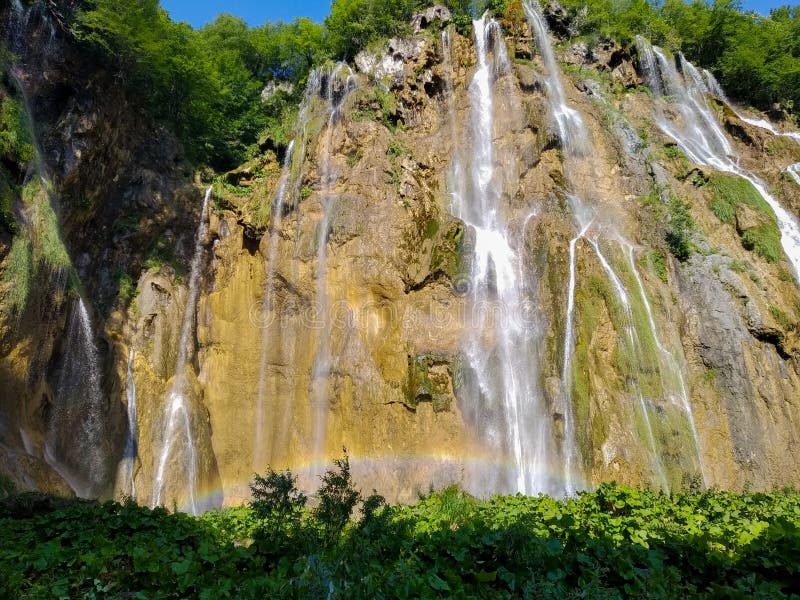 Huge Waterfall Over the Lake with a Rainbow Stock Photo - Image of ...