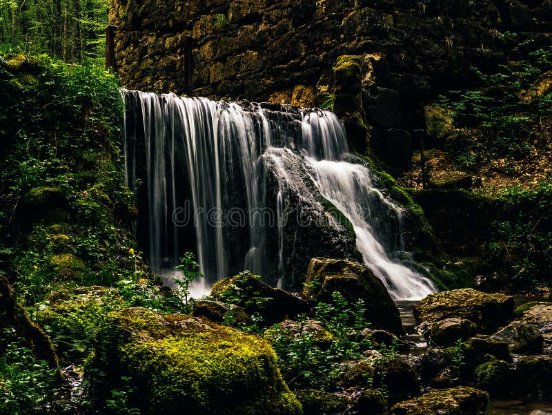 Huge Waterfall at the Ruins of an Old Mill in the Forest Stock Image ...