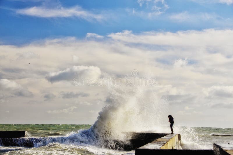 A Huge Wave and a Man on the Pier. Storm on the Sea Stock Image - Image ...