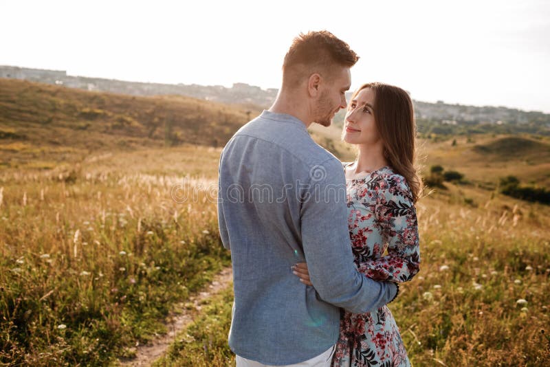 Hugging Couple Smiling and Looking at Each Other, Side View. the Origin ...