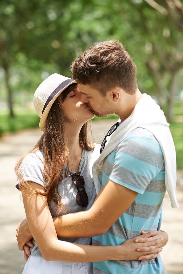 Hugging and kissing couple stock photo. Image of park - 59454944
