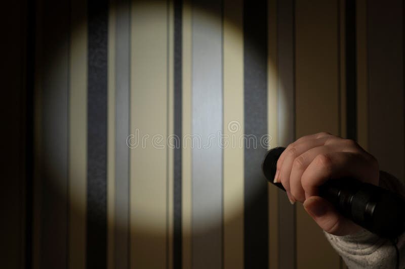 A Human in a Dark Room Holds a Hand-held Flashlight Stock Image - Image ...